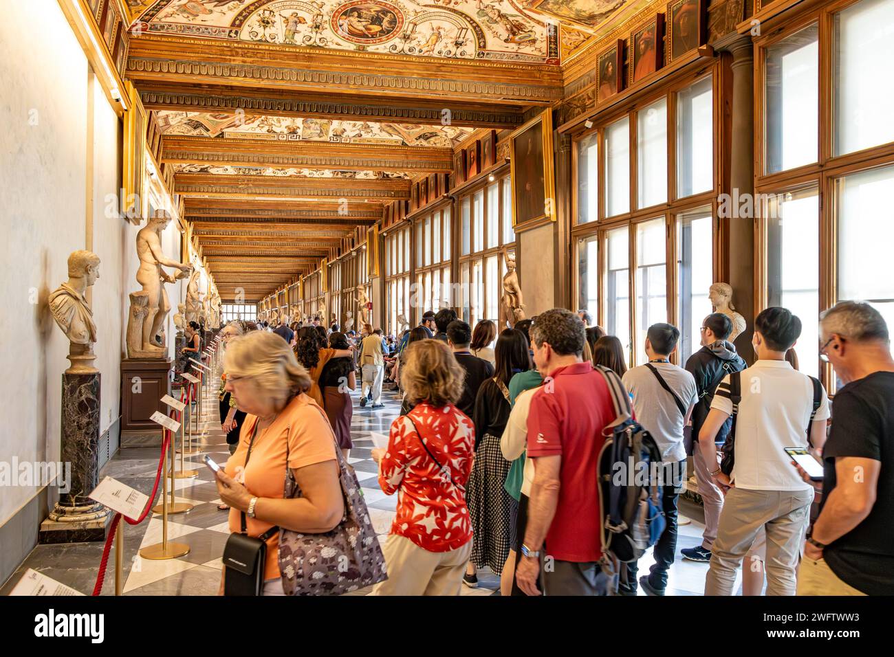 People admiring the art work inside The Uffizi Gallery ,one of the ...