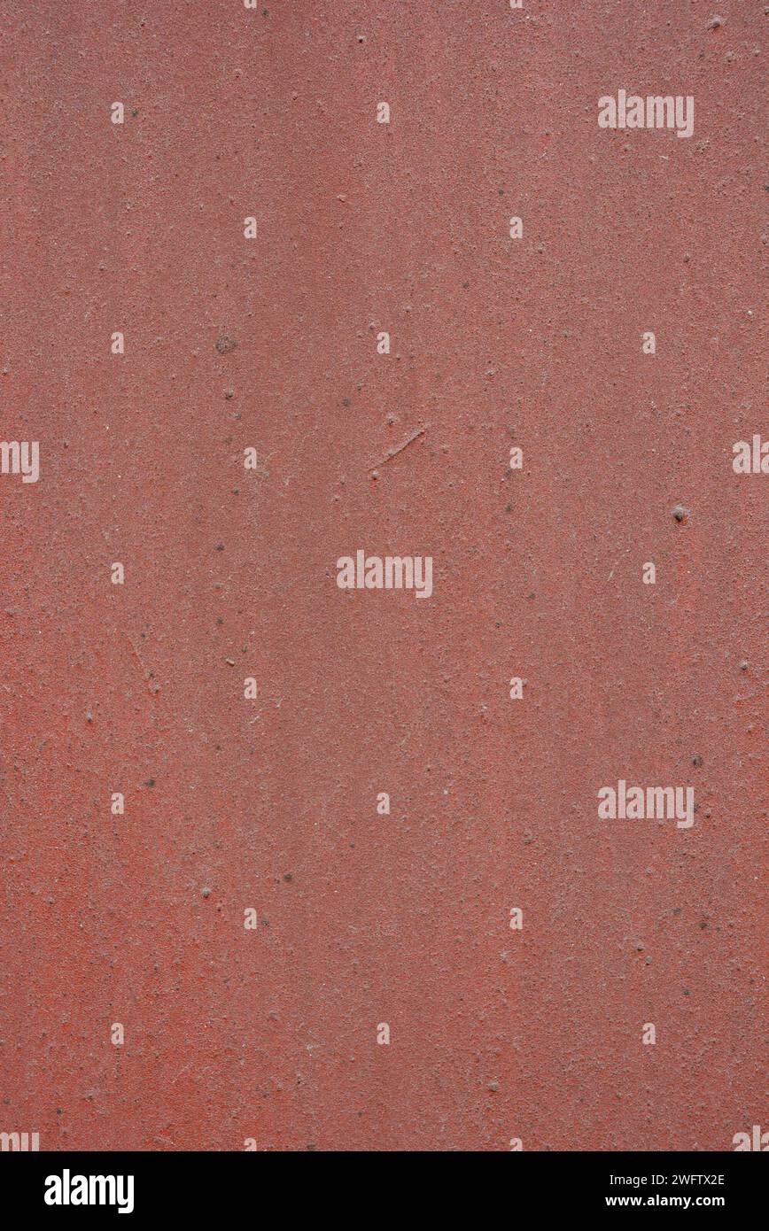 An old, uneven, metal surface with bumps covered with brown, red ...