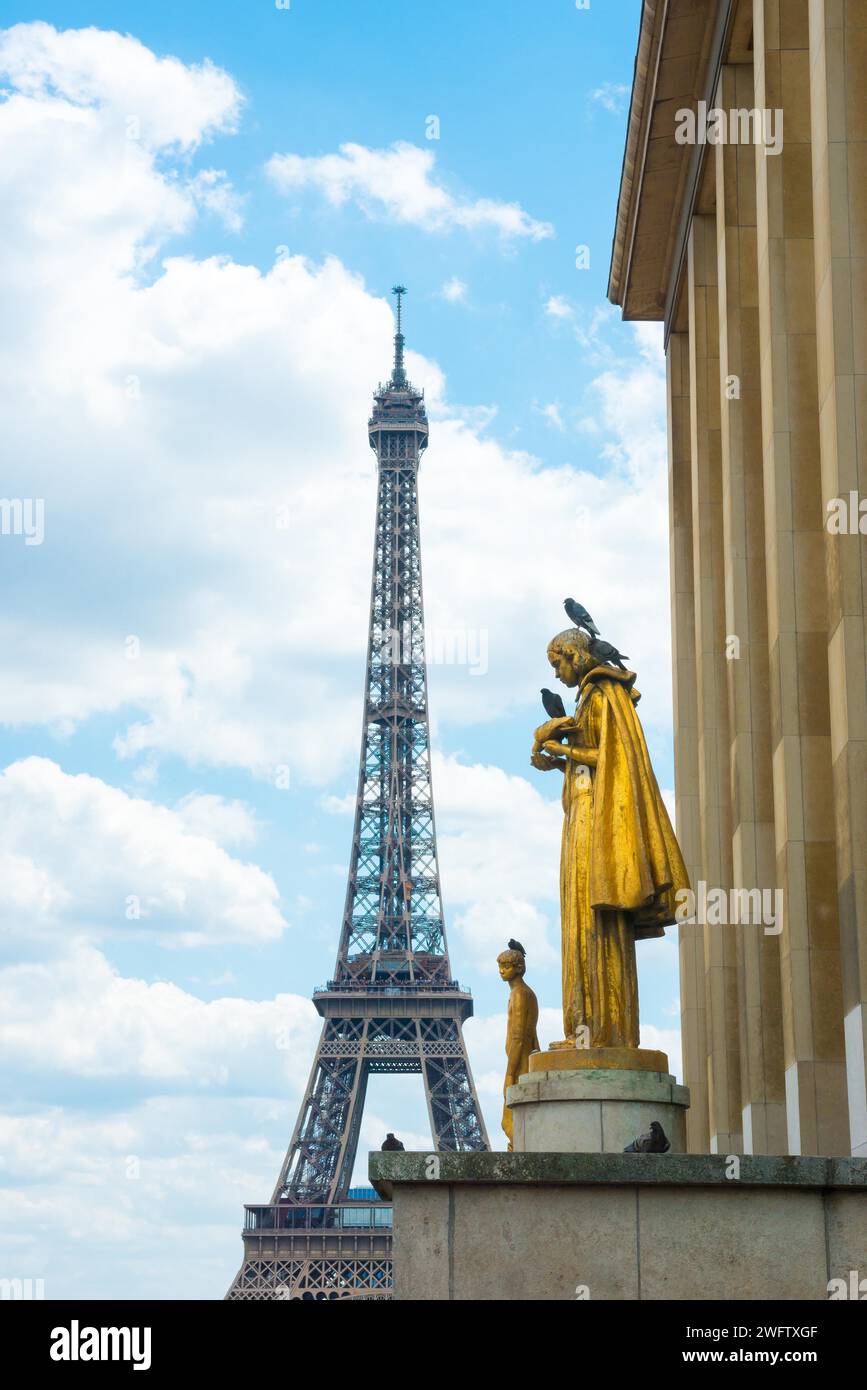 Eiffel Tower and golden statue Les Oiseaux (a woman feeding pigeons) by ...