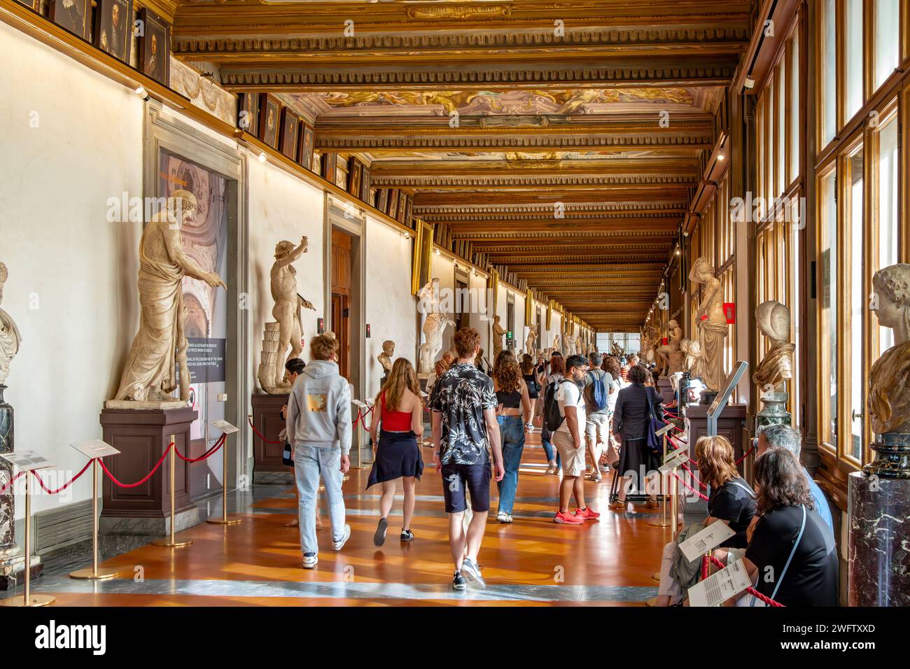 People admiring the art work inside The Uffizi Gallery ,one of the ...