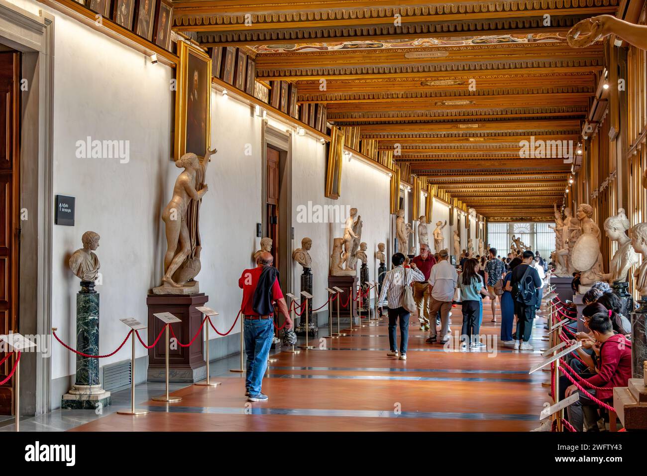People admiring the art work inside The Uffizi Gallery ,one of the ...