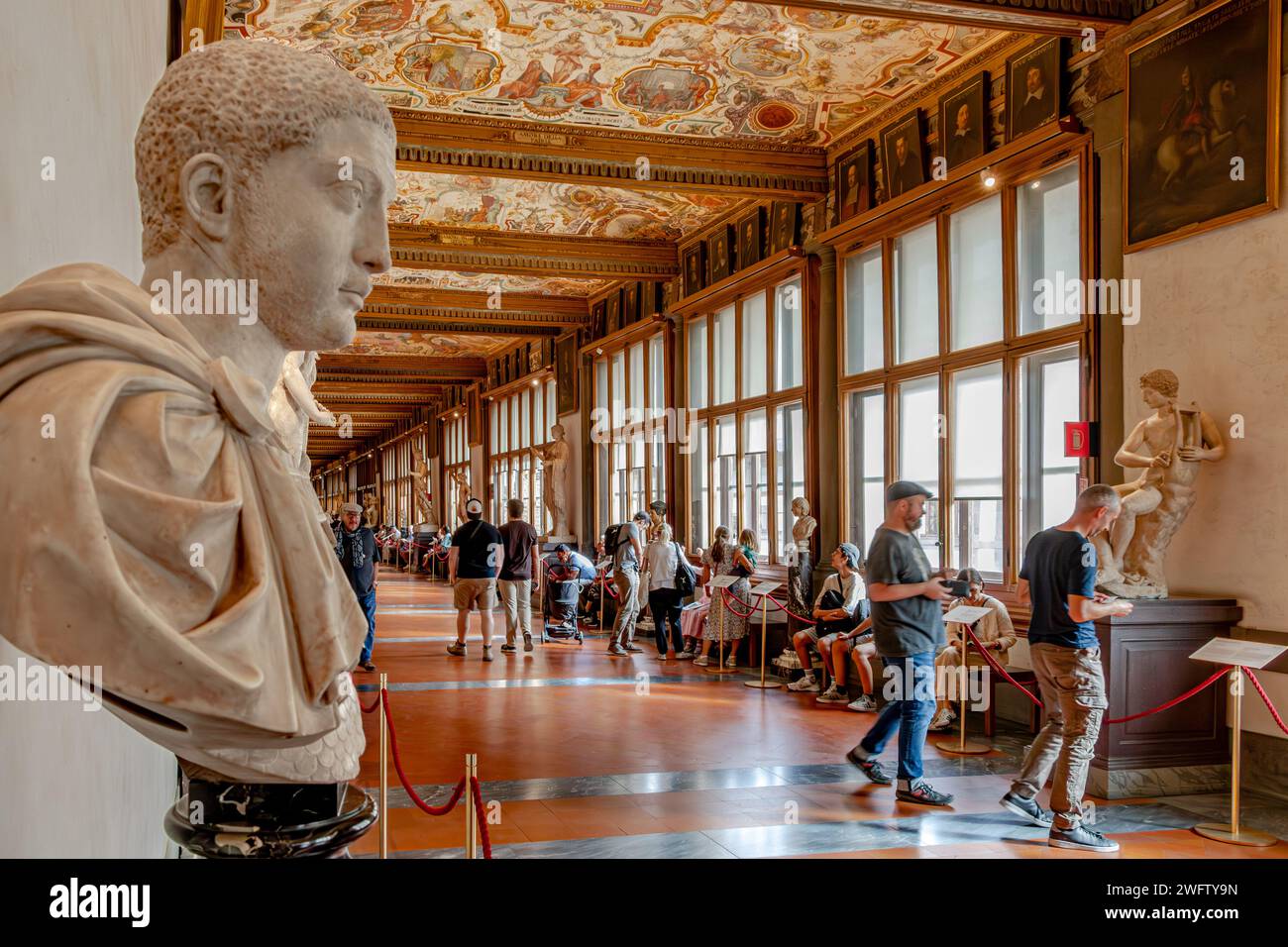 People admiring the art work inside The Uffizi Gallery ,one of the ...