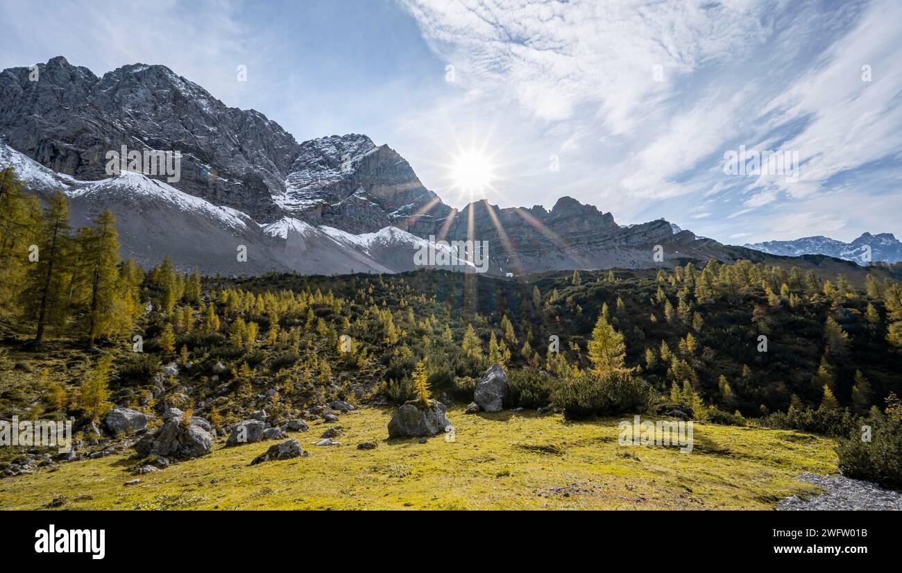 Mountain panorama with rocky steep peaks, yellow coloured larches in ...