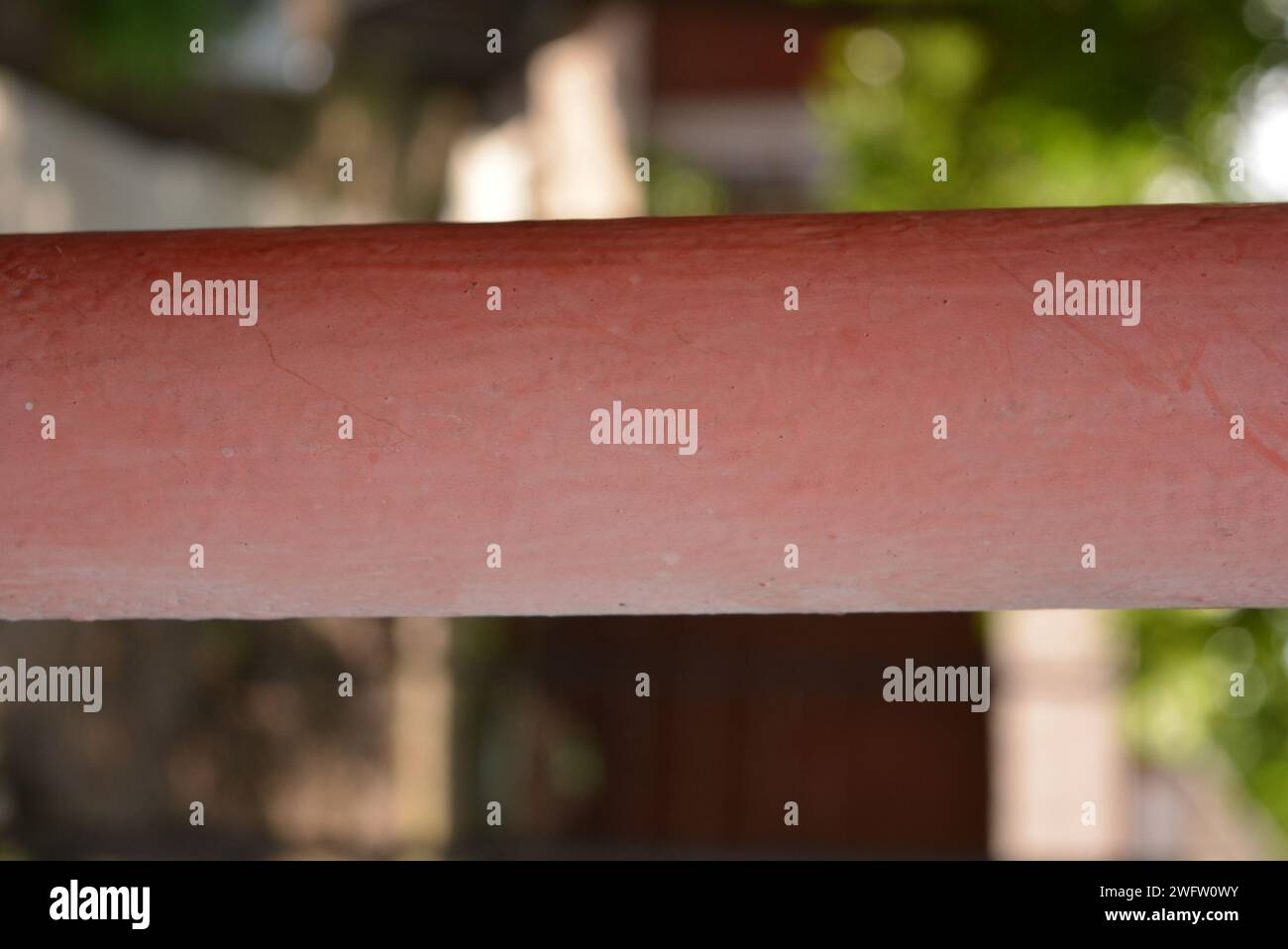 Building materials, an old gas pipe with faded red paint located in the ...