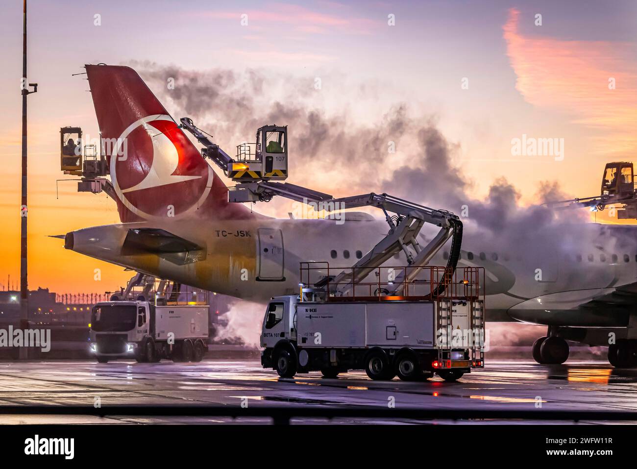 Frost at the airport, a Turkish Airlines aircraft is de-iced in front ...