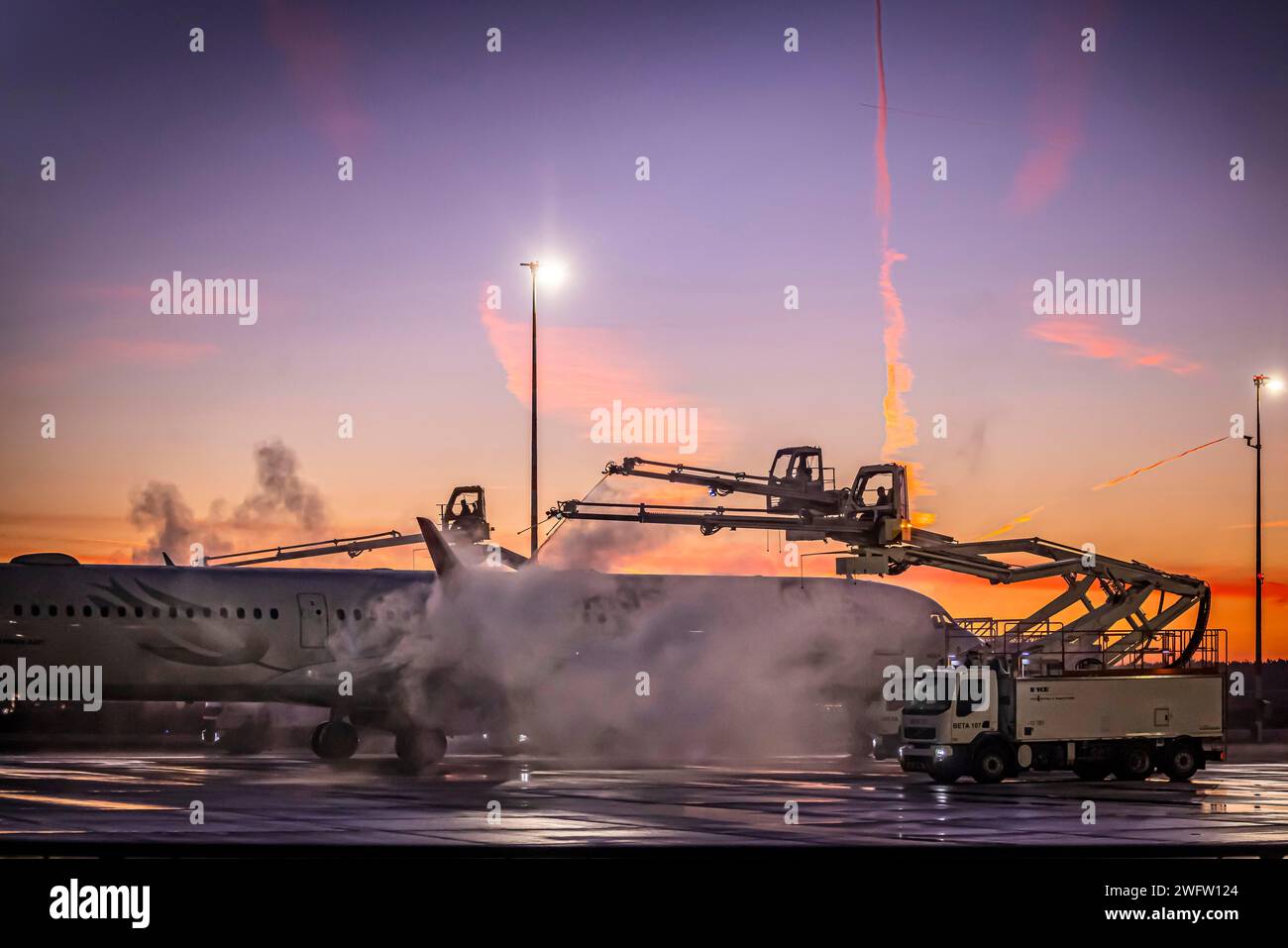 Frost at the airport, a Turkish Airlines aircraft is de-iced in front ...
