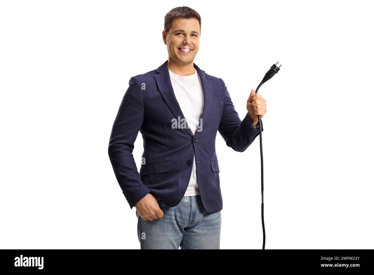 Man holding an electric cable with a plug and smiling isolated on white ...