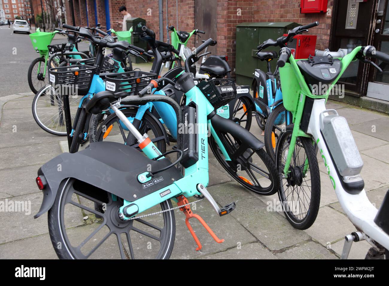 Tier, Lime and River e-Bike Dockless Bicycle Hire System on Pavement Chelsea London England ...