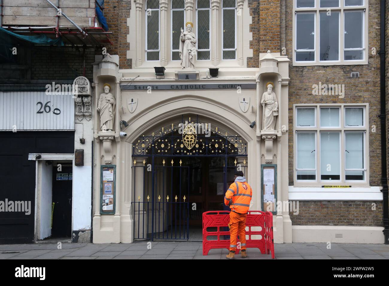 Workman Outside the Entrance of Servite Catholic Church (Our Lady of ...