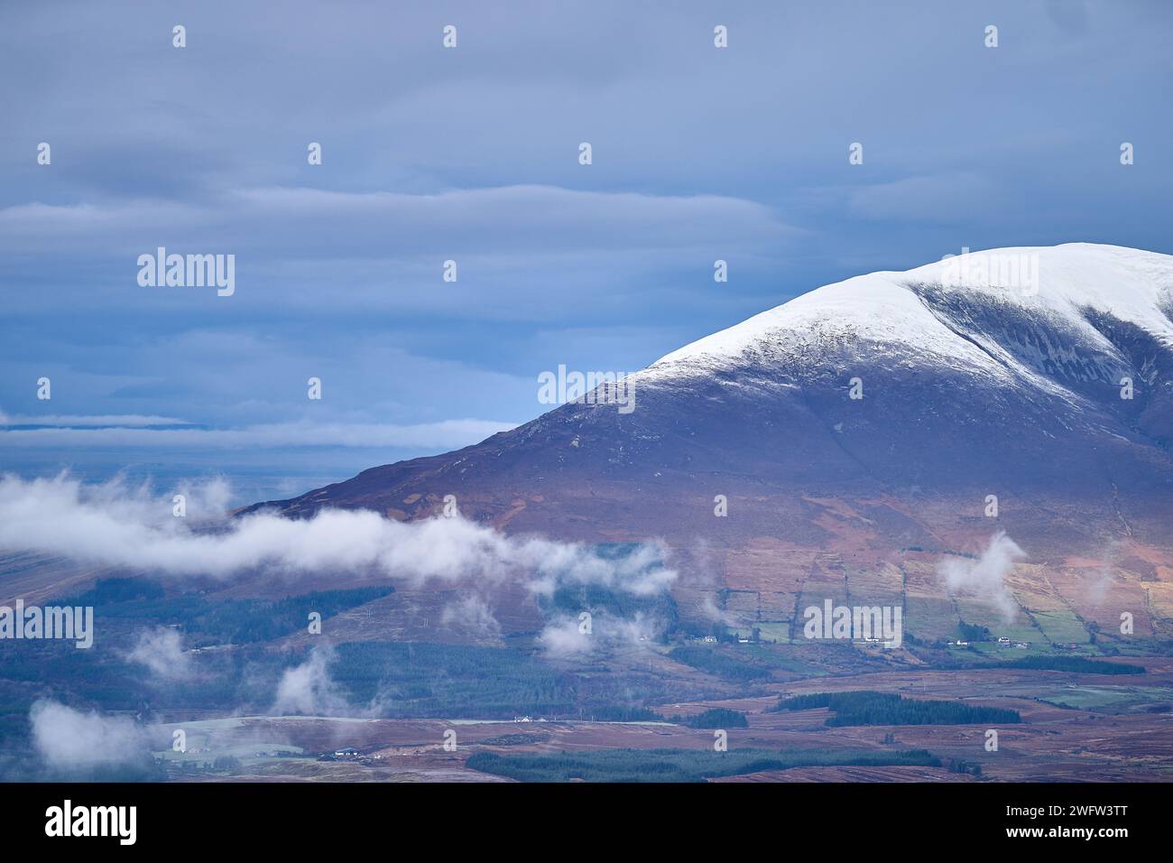 Snow on Nephin mountain dramatic sky low clouds Ireland Stock Photo - Alamy