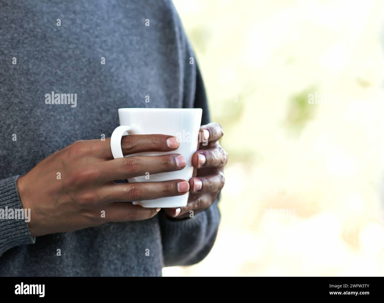 African guy holding coffee mug hi-res stock photography and images - Alamy