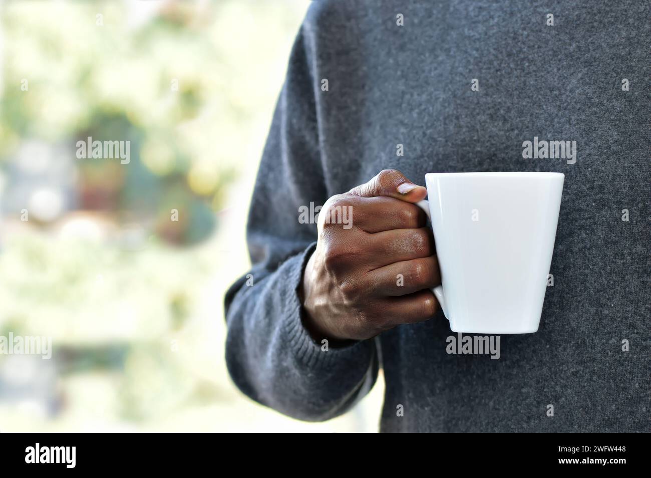 African guy holding coffee mug hi-res stock photography and images - Alamy