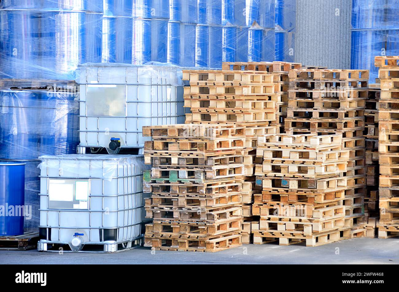A stack of freight containers in rows at the factory with liquid inside ...