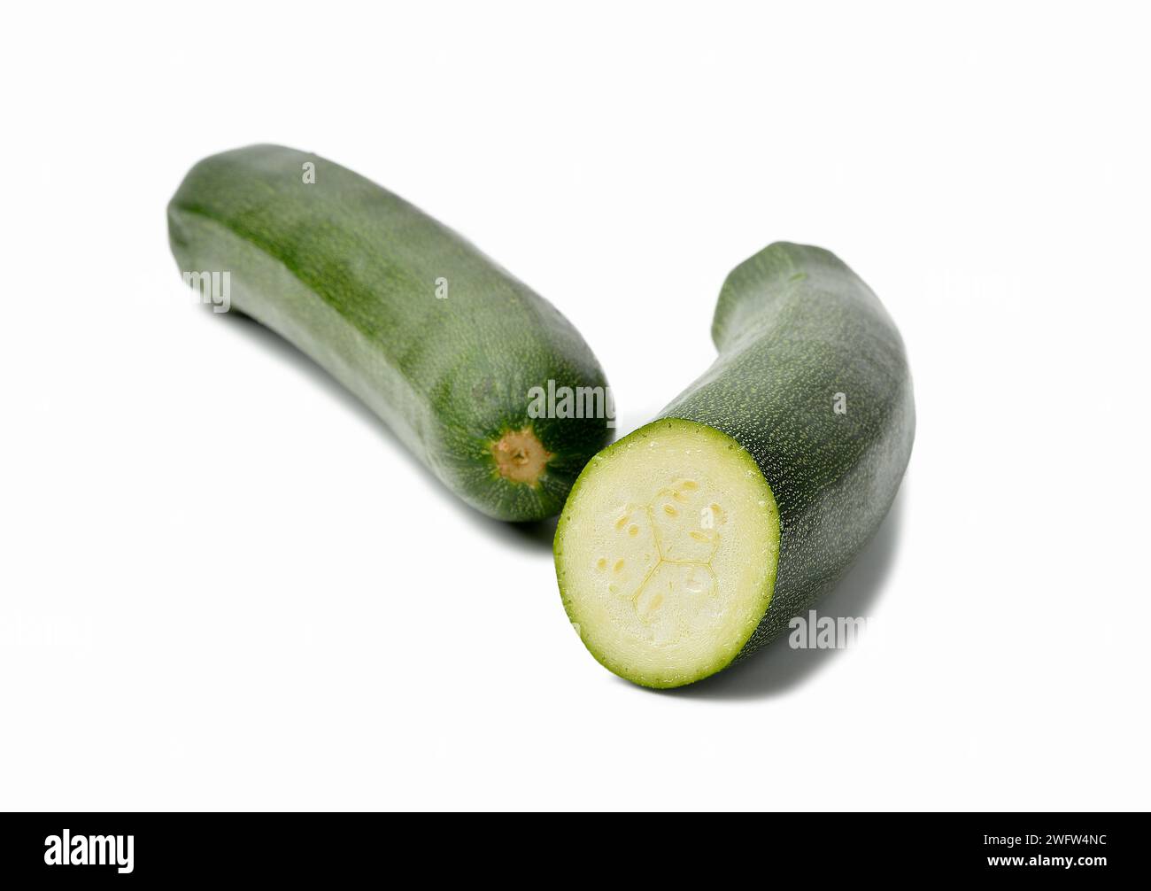 View of a fresh sliced cucumber isolated on white Stock Photo - Alamy