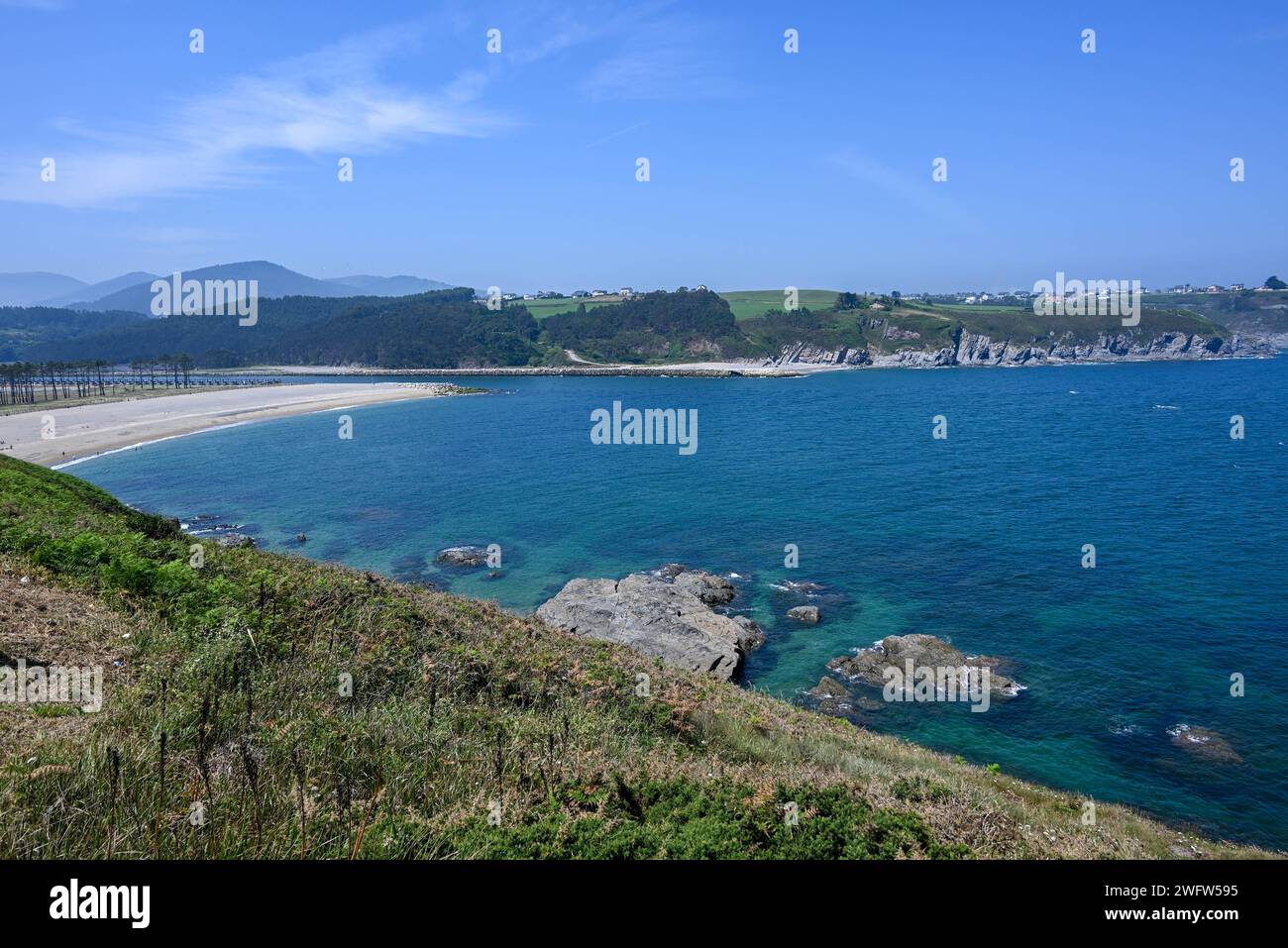 An aerial view of ocean waters with numerous rocky formations in Navia ...