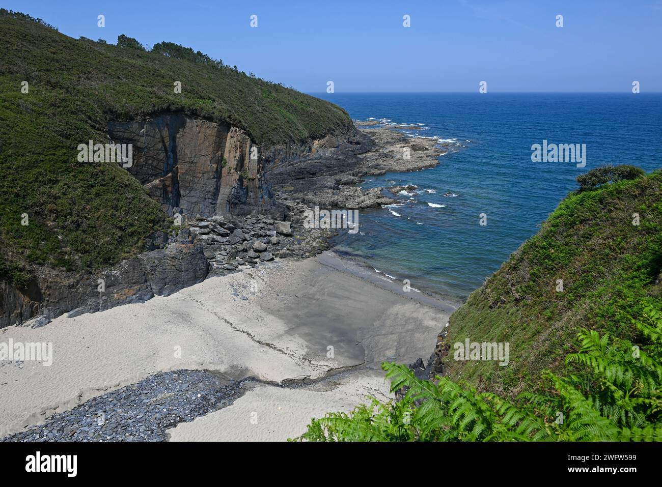 An aerial view of rocks on a beach shoreline with water in Navia Stock ...