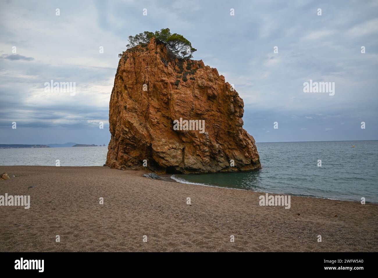 A stunning beach view with the Illa Roja rock formation Stock Photo - Alamy
