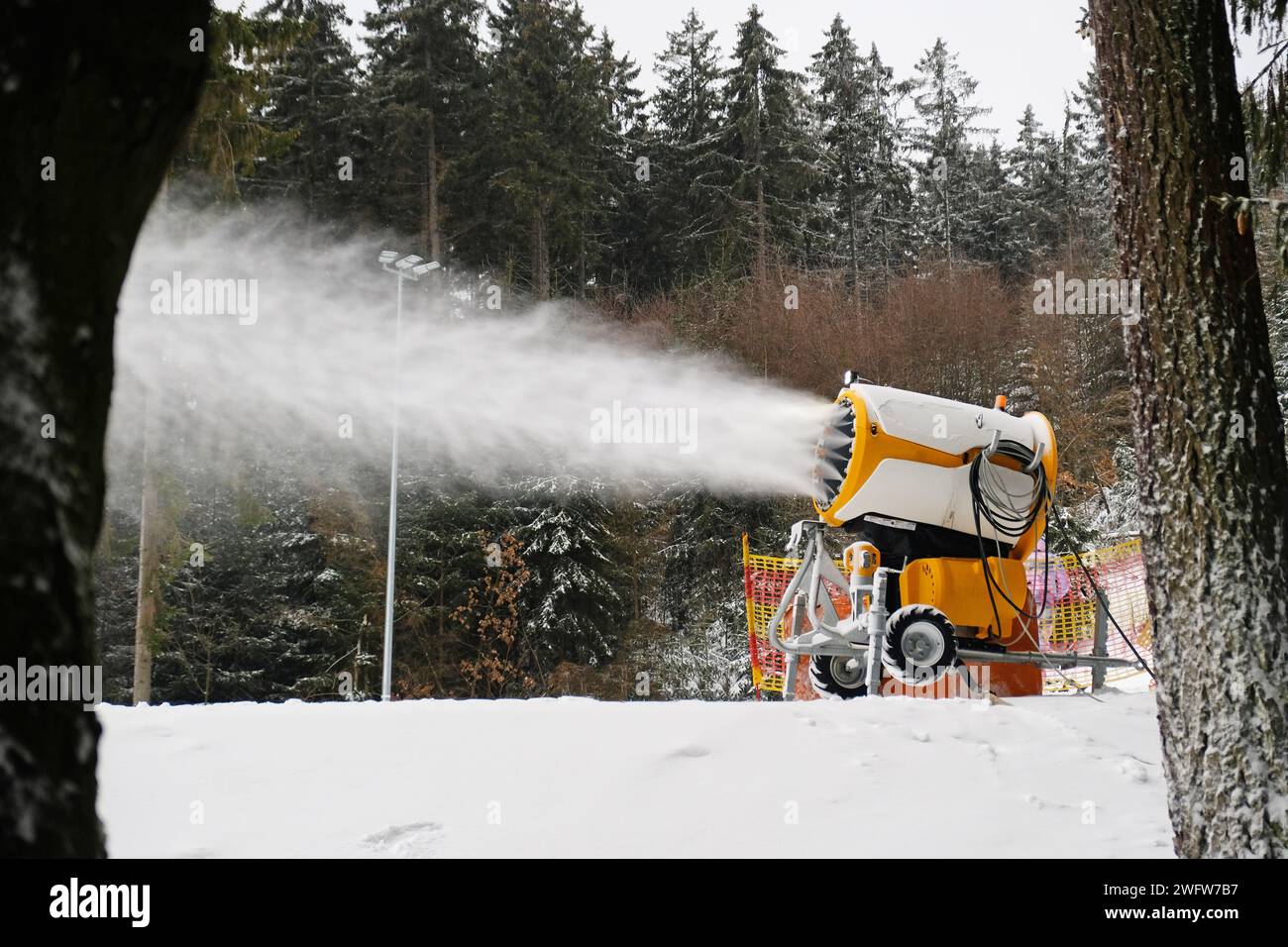 Snow cannon makes artificial snow. Snowmaking systems sprays water to ...
