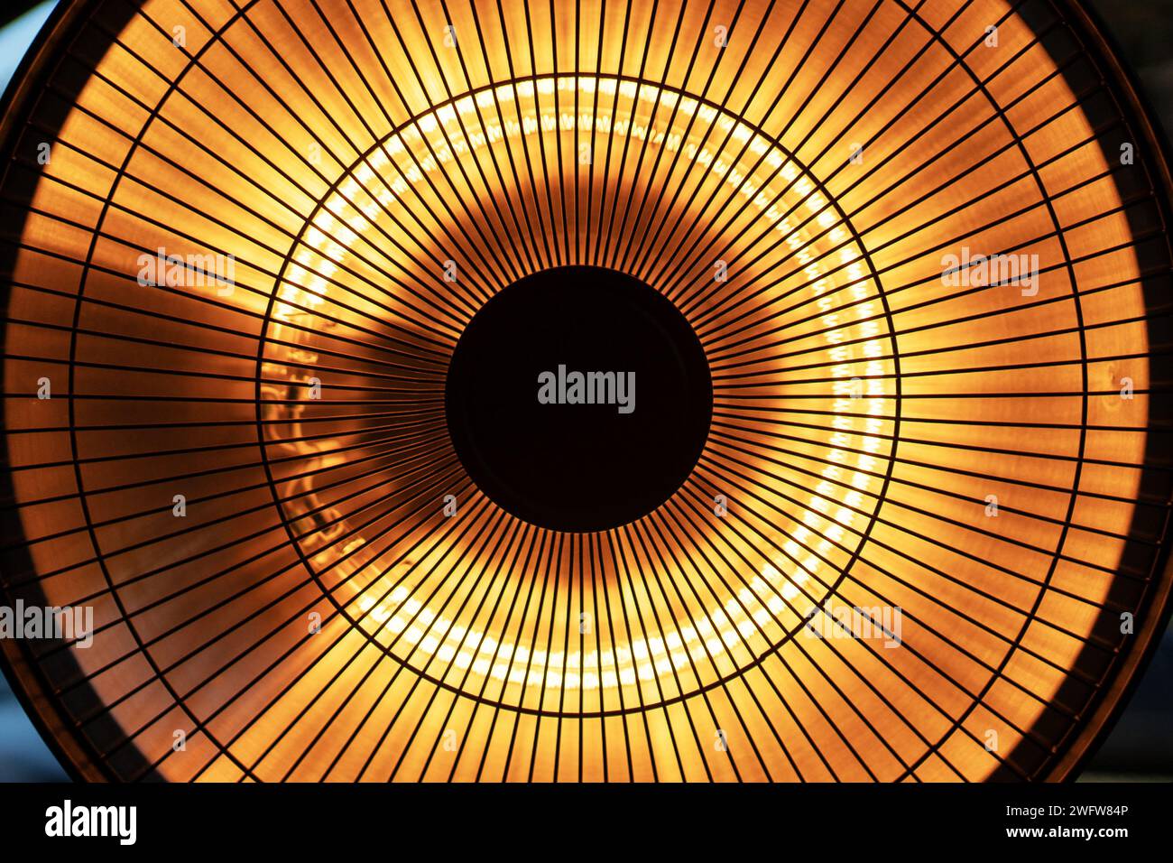 Detailed close up view of round electric heater in orange and yellow ...