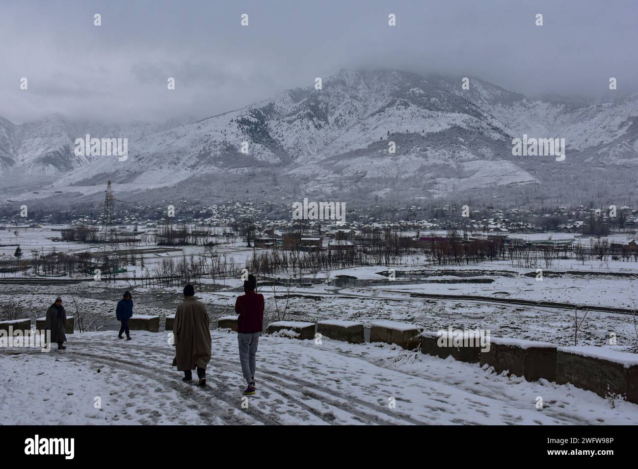 Kashmir, India. 1st Feb, 2024. Residents walk through a snow covered ...