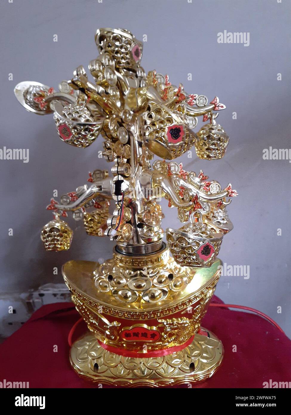 Statue atop plate on table Stock Photo - Alamy