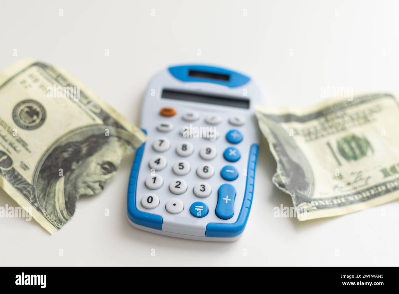 One Hundred Dollar Bill Ripped in Half Isolated on a White Background ...