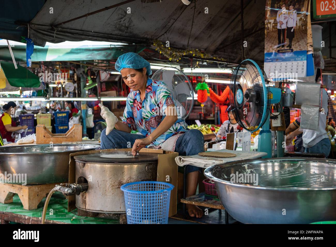 A local worker seen making Thai roti a traditional recipe, at Rama IV ...