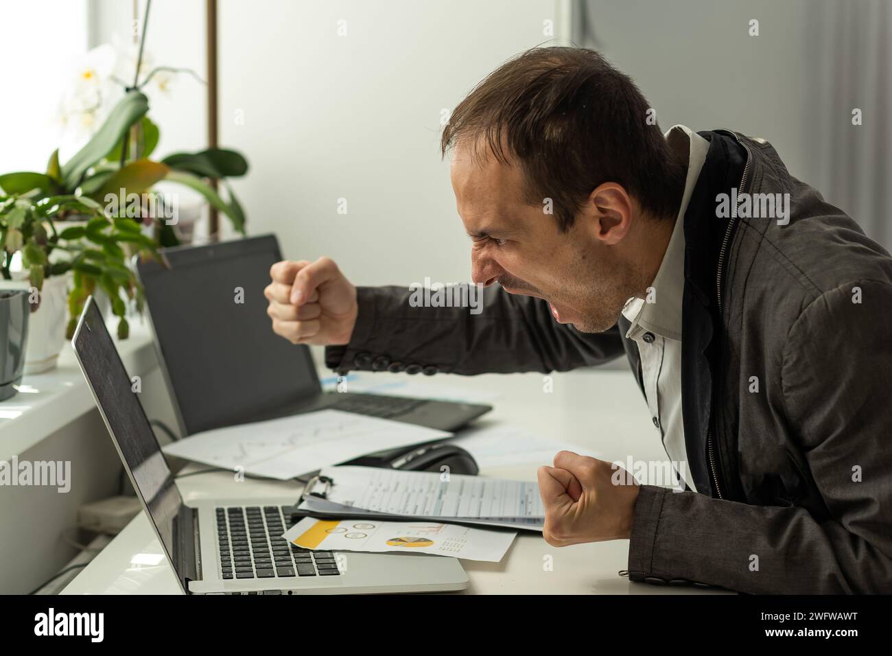 Angry annoyed frustrated caucasian business man, sitting at workplace ...