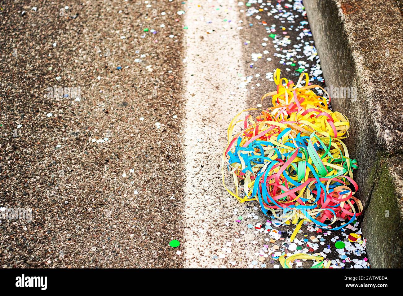 Close up colorful confetti and streamers at the street after Carnival ...