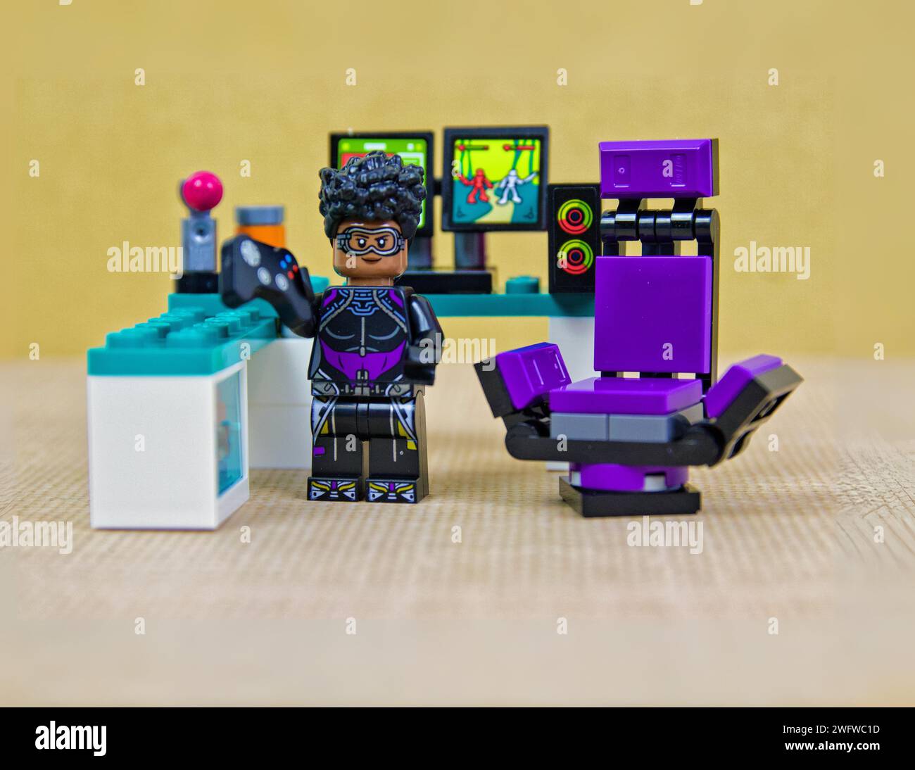 Toy gamer character, smiling having fun playing video programs with ...