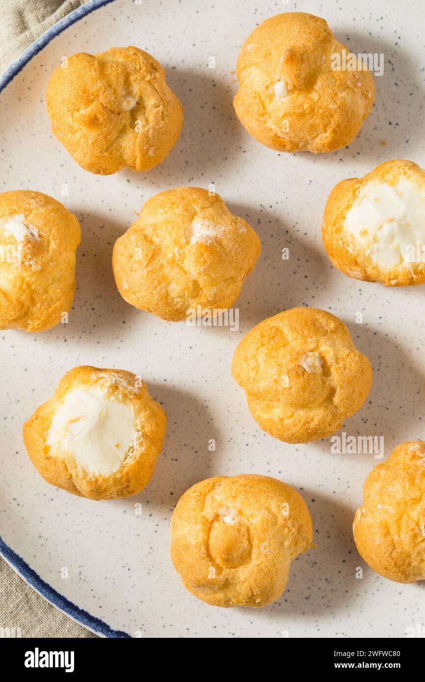 French Homemade Mini Cream Puff with whipped Filling Stock Photo - Alamy