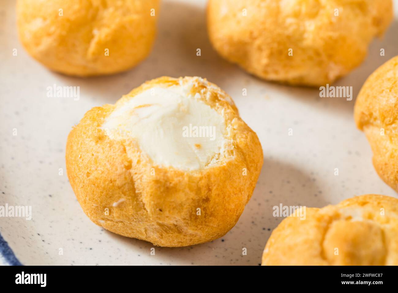 French Homemade Mini Cream Puff with whipped Filling Stock Photo - Alamy