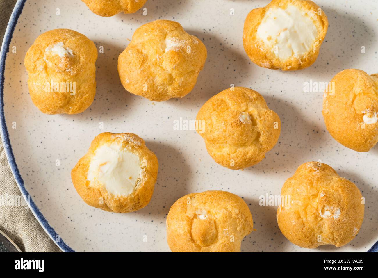 French Homemade Mini Cream Puff with whipped Filling Stock Photo - Alamy
