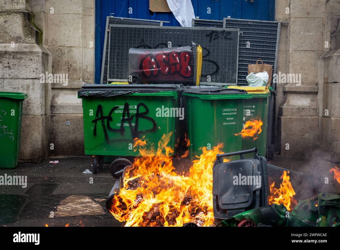 Trash cans seen burning at the main entrance of Voltaire High School ...