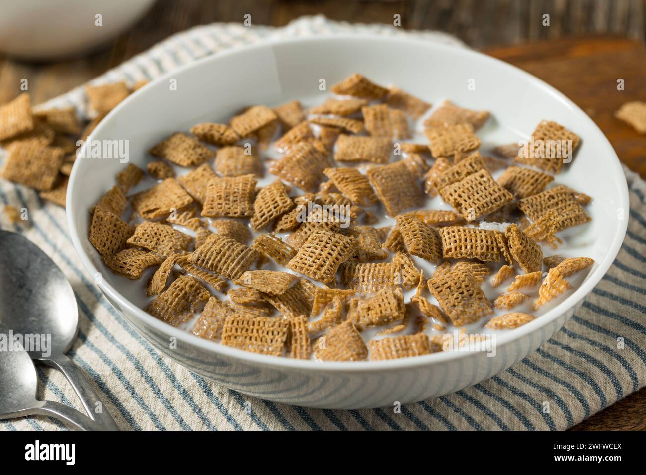 Healthy Wheat Squares Breakfast Cereal with Whole Milk Stock Photo - Alamy