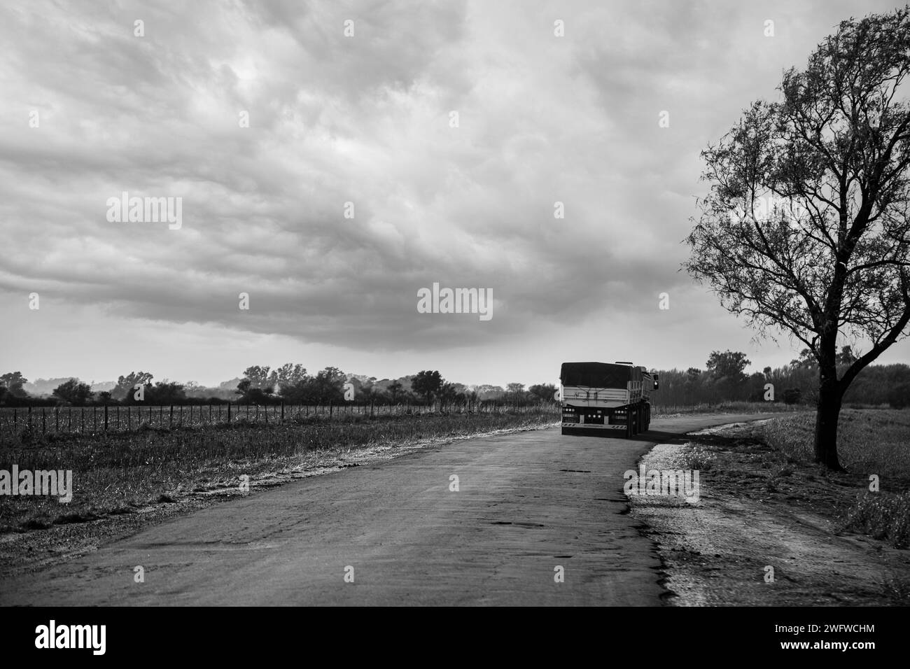 Desolate old route, surrounded by fields. Cloudy day Stock Photo - Alamy