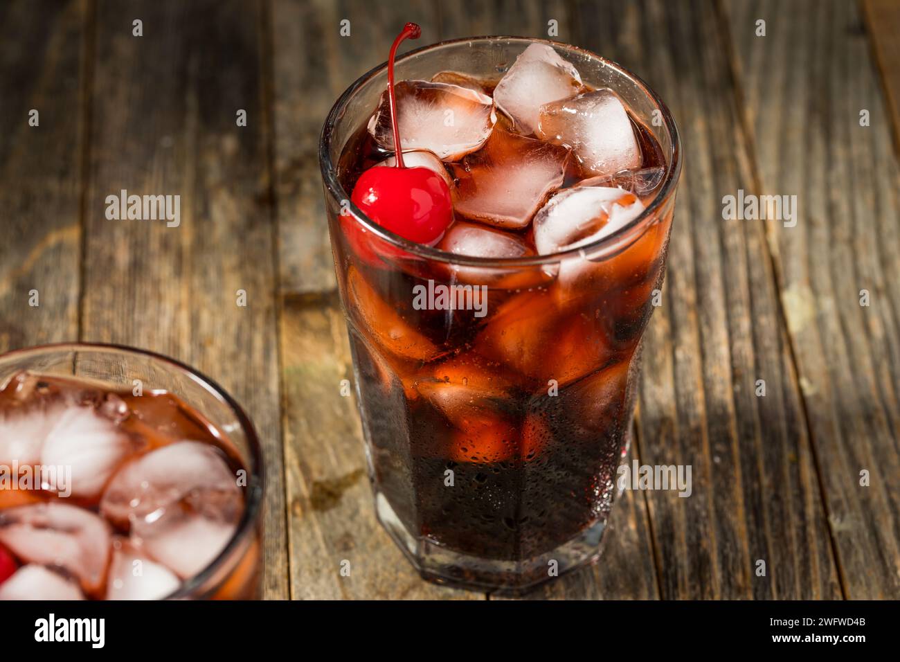 Cold Refreshing Cherry Cola with Ice in a Glass Stock Photo - Alamy