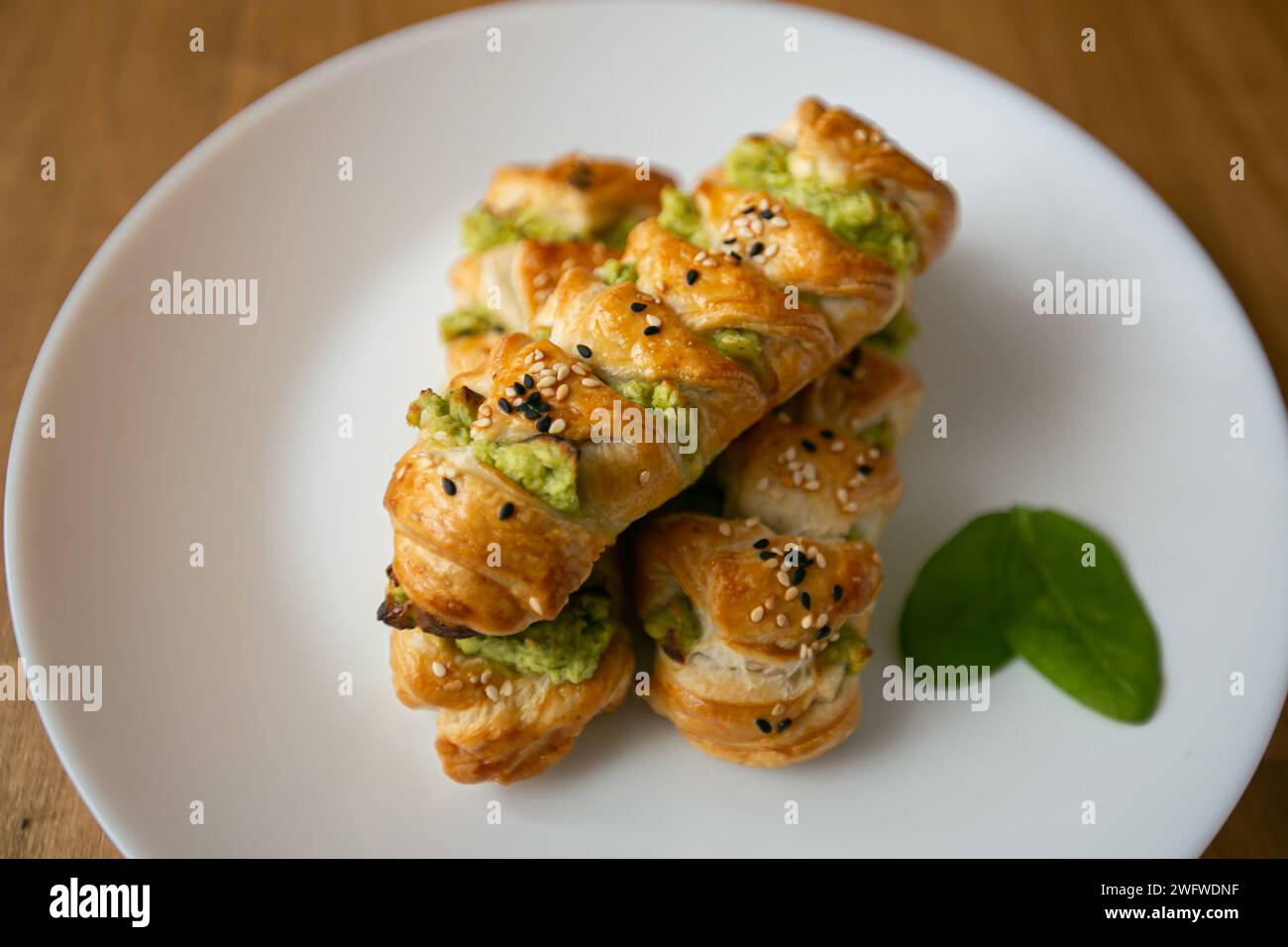 Turkish borek rolls with spinach and cheese on the white plate. A ...