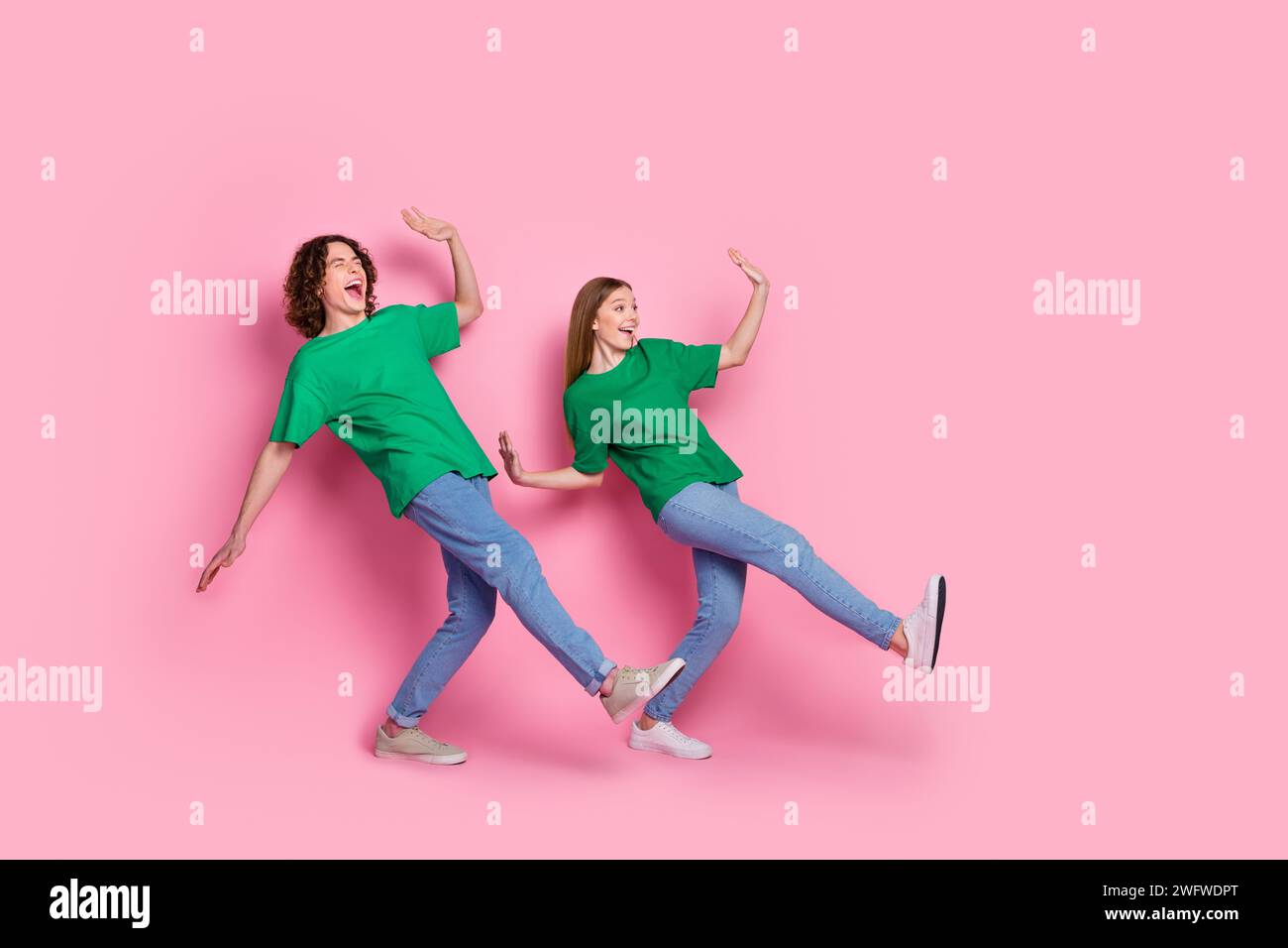 Full length body photo of two best friends teenagers synchronized moves ...