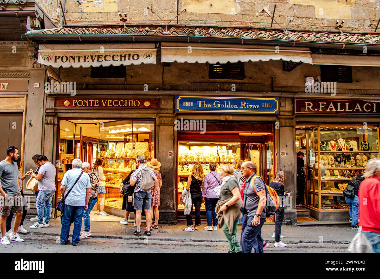 Crowds of people walking on the Ponte Vecchio bridge browsing the many ...