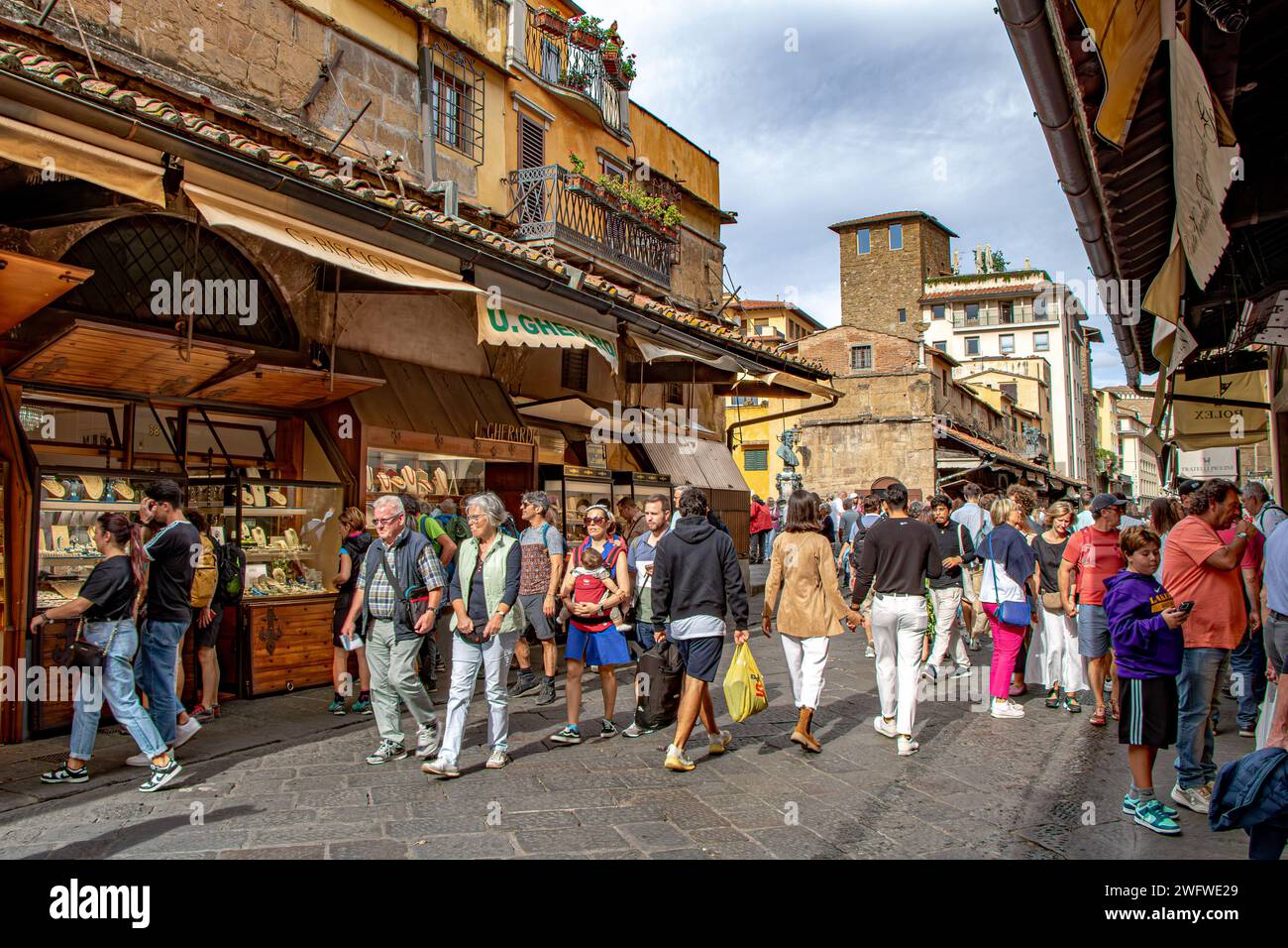 Crowds of people walking on the Ponte Vecchio bridge browsing the many ...