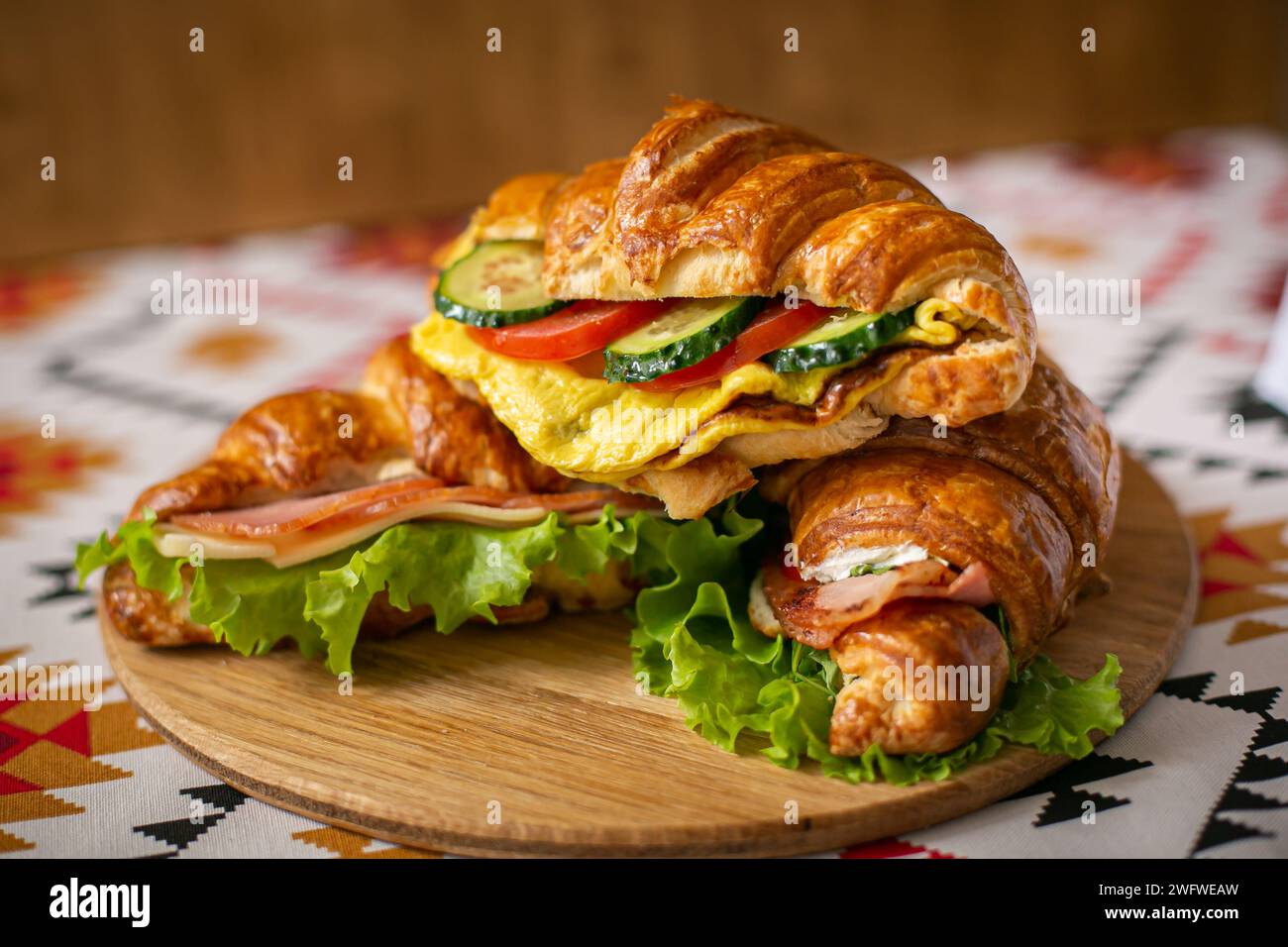 different croissant assorted in restaurant on a wooden plate. croissant ...