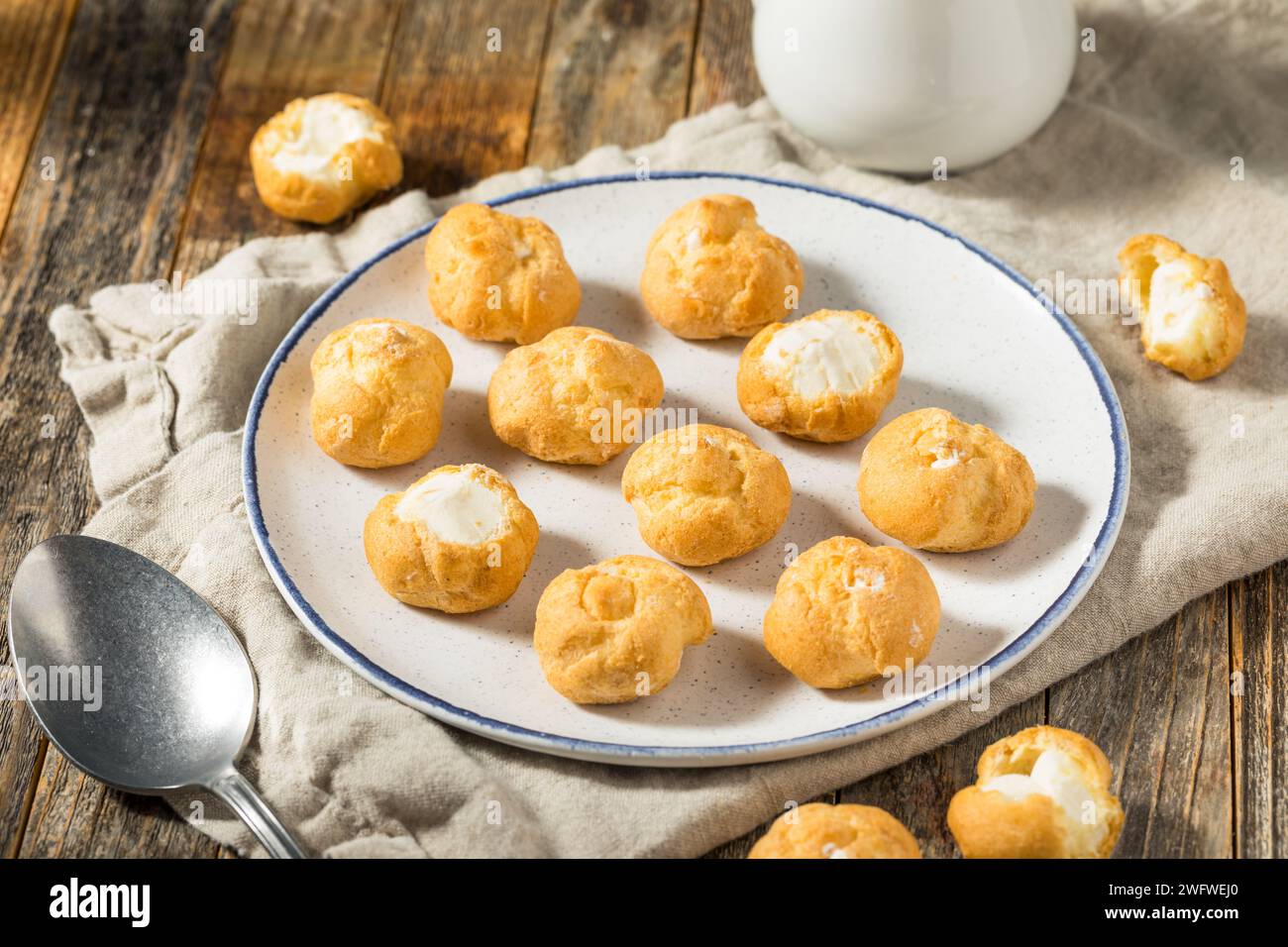 French Homemade Mini Cream Puff with whipped Filling Stock Photo - Alamy