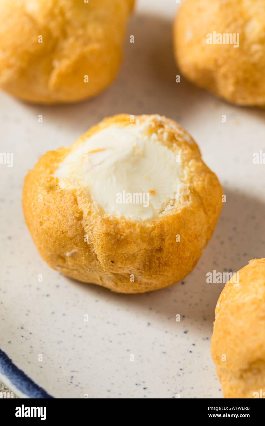 French Homemade Mini Cream Puff with whipped Filling Stock Photo - Alamy