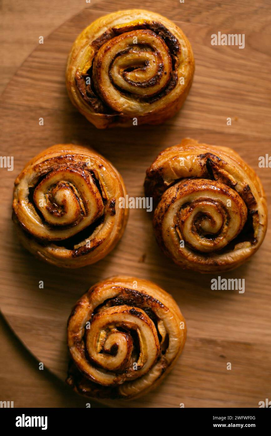 Rolls Cinnabon cinnamon and sugar, on a wood round dish isolated over ...