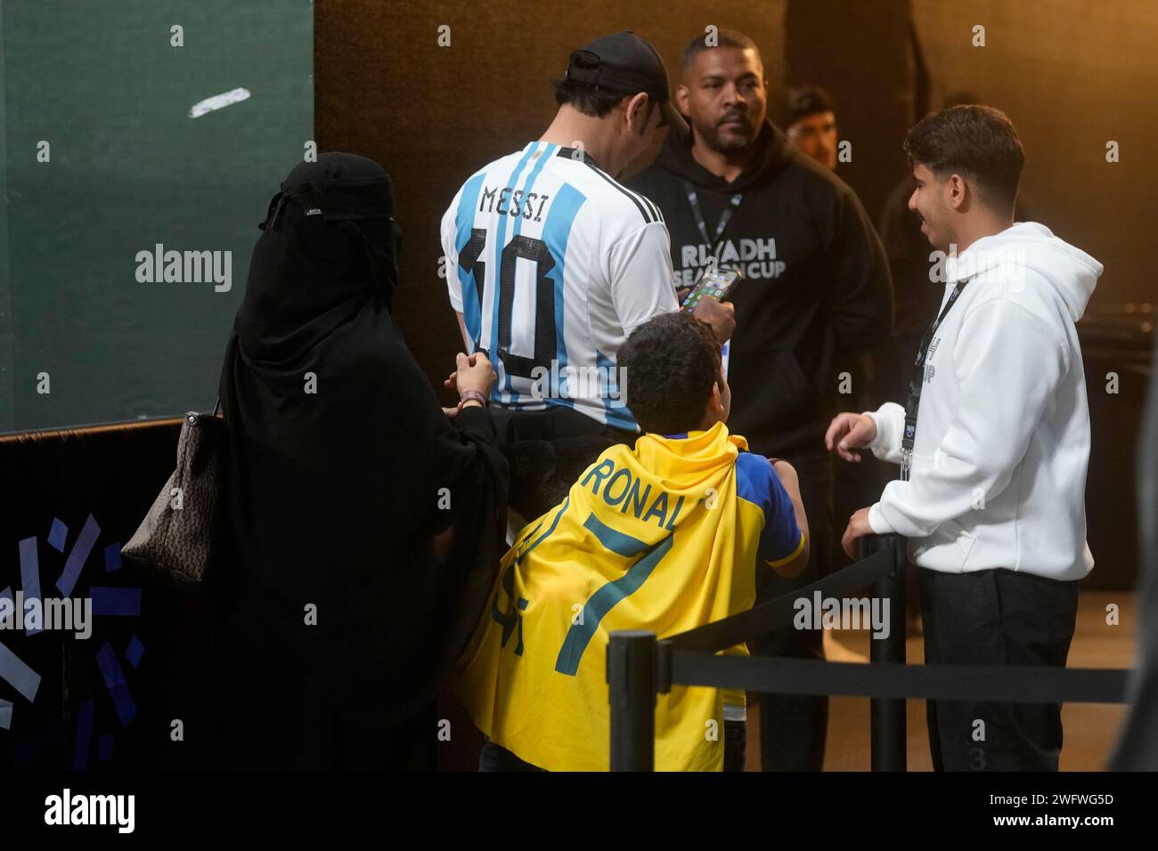 Saudi family members wear T-shirts of Lionel Messi and of Cristiano ...