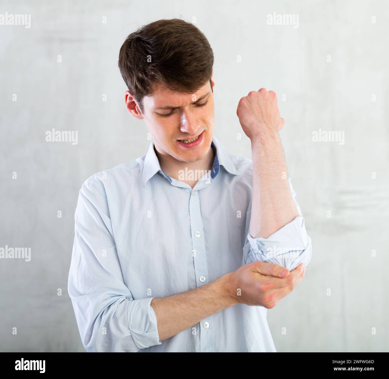 Man experiencing acute pain in his elbow Stock Photo - Alamy