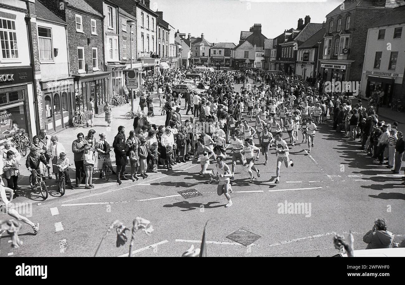 1987, spectators roadside watching competitors taking part in fun run ...