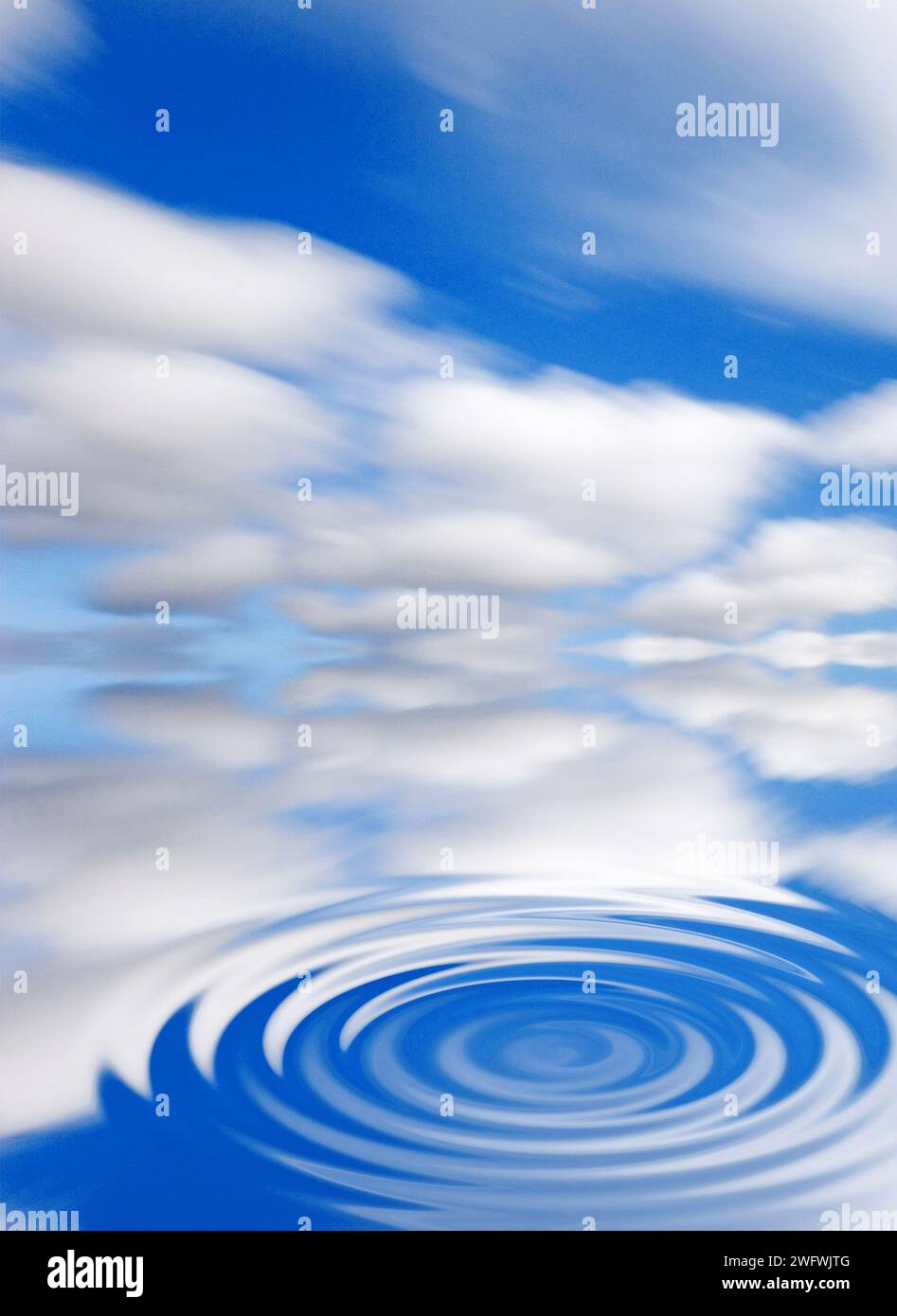 concentric waves on a water surface with blue sky and white clouds ...