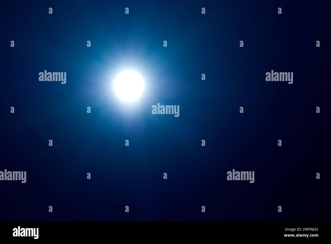 Sun in the dark blue sky Stock Photo - Alamy